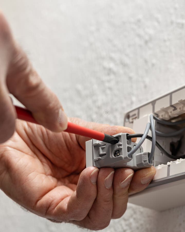 Electrician at Work on a Residential Electrical System. Electricity ...