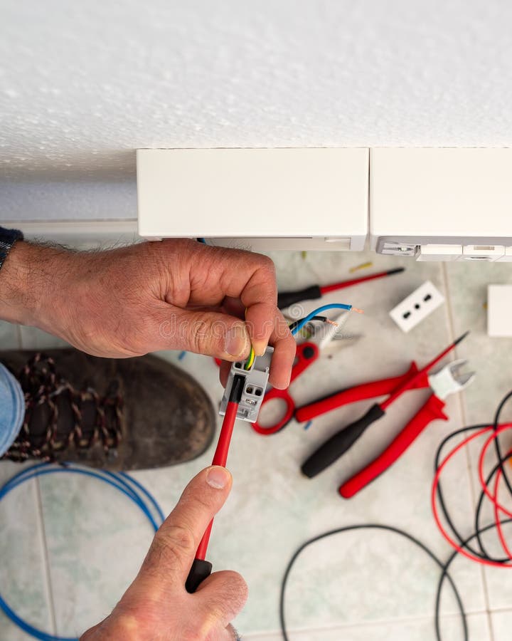 Electrician at Work on a Residential Electrical System. Electricity ...