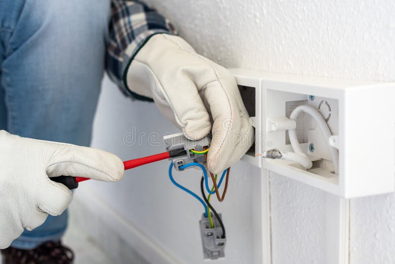 Electrician at Work on a Residential Electrical System. Electricity ...