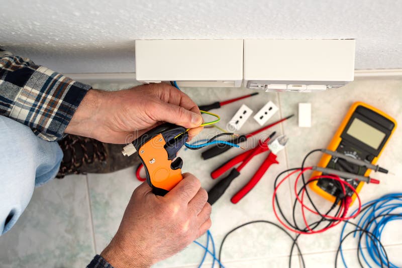 Electrician at Work on a Residential Electrical System. Electricity ...