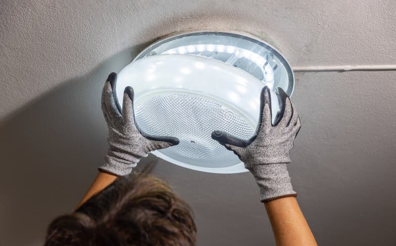 Electrician Worker Remove and Clean a Ceiling Light Cover Inside ...