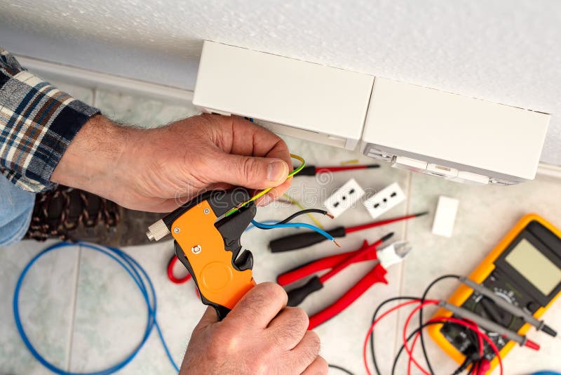 Electrician at Work on a Residential Electrical System. Electricity ...