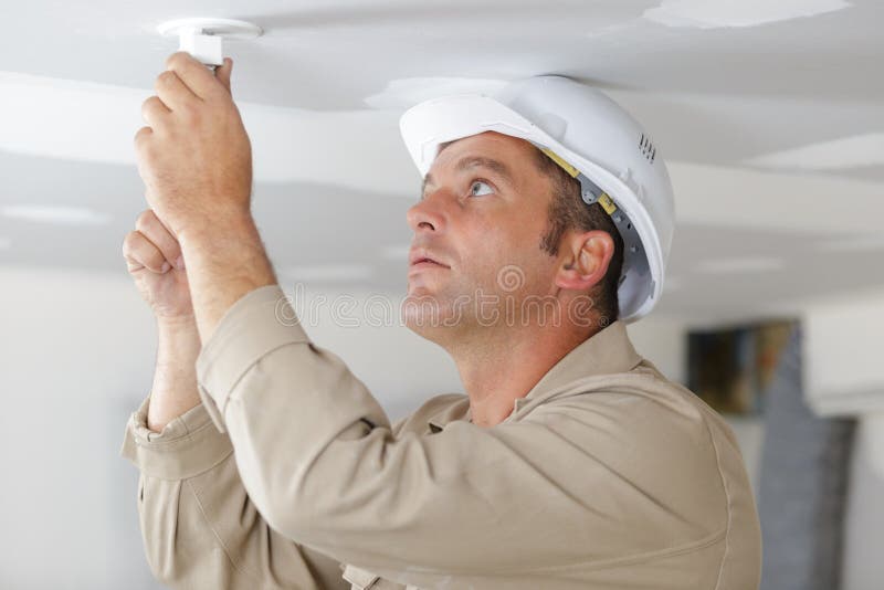 Electrician Working on Ceiling Light Fitting Stock Image - Image of ...