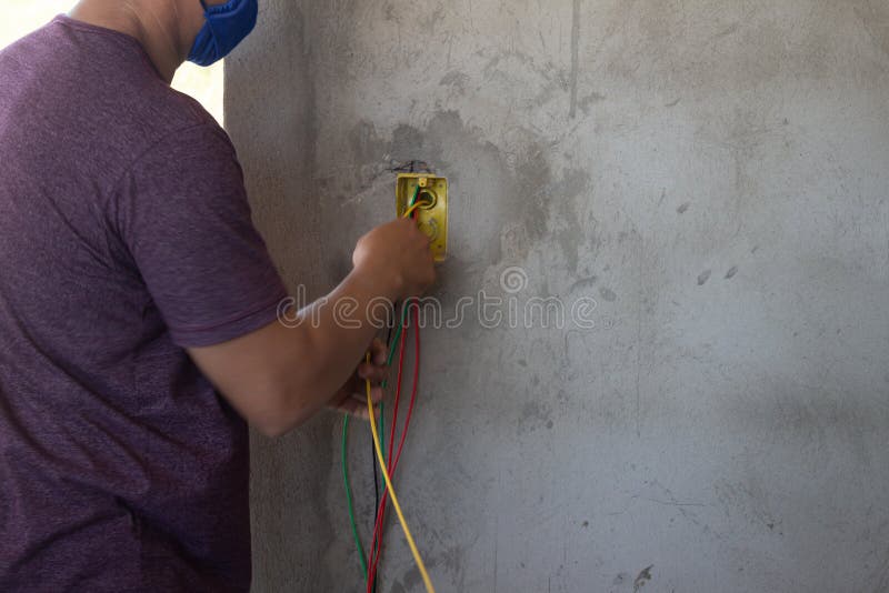 Electrician Working on a Construction Site. Electrical Wiring in a ...
