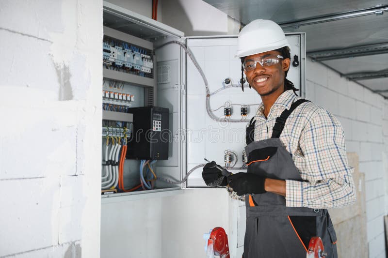Electrician Working on Control Panel in Building Under Construction ...