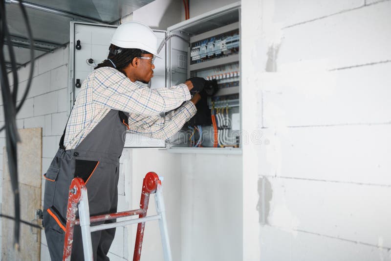 Electrician Working on Electrical Panel in Building Under Construction ...