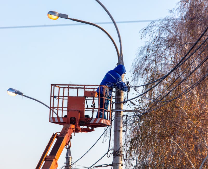 An Electrician is Working on a Pole Stock Image - Image of power ...