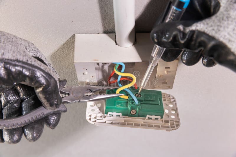 Electrician Working Safely on Sockets of a Residential Electrical ...