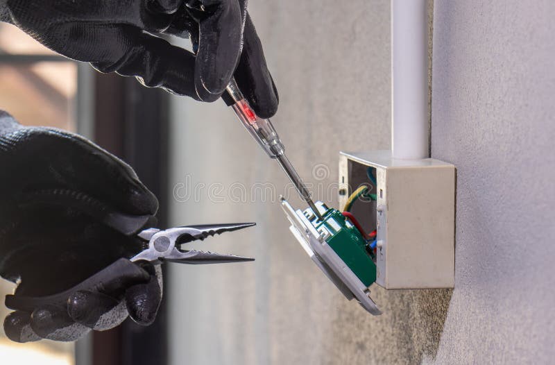 Electrician Working Safely on Sockets of a Residential Electrical ...