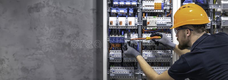 Electrician Working in Switchboard with Electrical Connection Cable ...