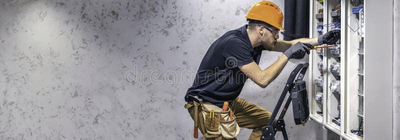 Electrician Working in Switchboard with Electrical Connection Cable ...