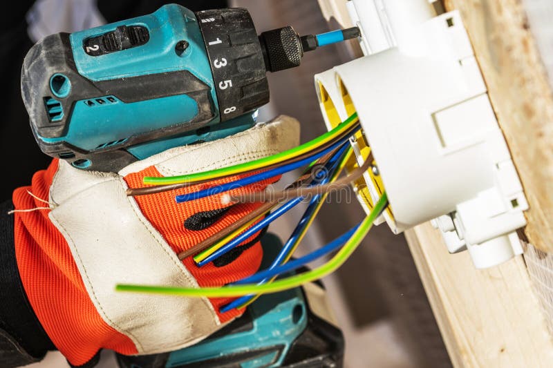 Electrician Working on Wiring Installation with Power Drill and a ...