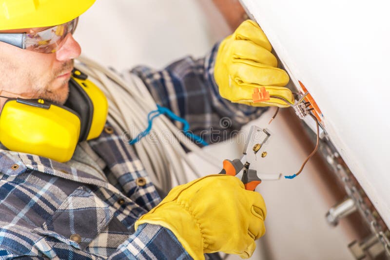 Electrician Working on Wiring Installation in a Residential Setting ...