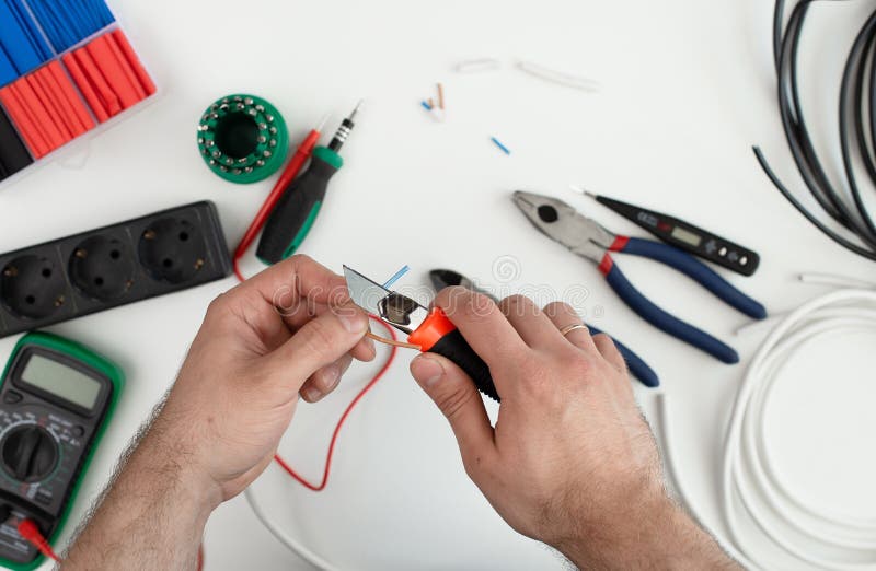 Electrician Works with a Tool on a White Background Stock Photo - Image ...