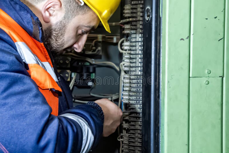 Electrician with a Yellow Helmet Working in a Power Station Stock Image ...