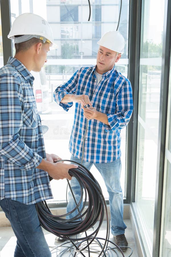 Electricians with Construction Tools and Cable Stock Photo - Image of ...