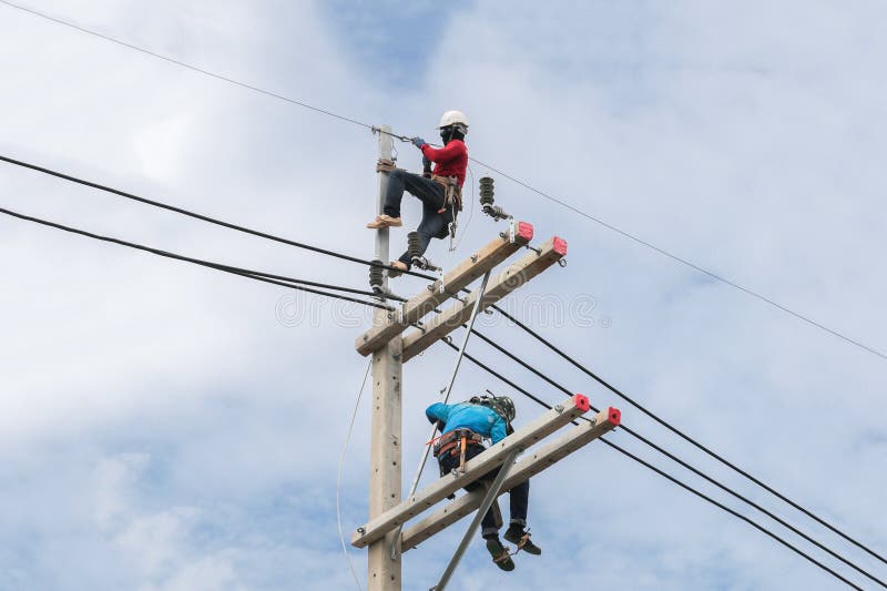 Electricians Working on Power Pole Connecting Cables. Stock Image ...