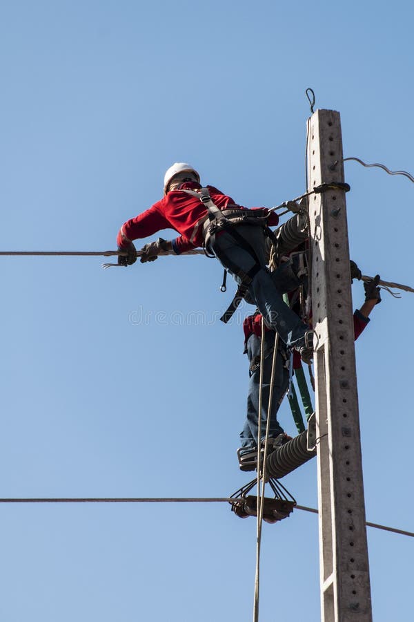 Electricians Working on a Pylon Stock Image - Image of power, city ...