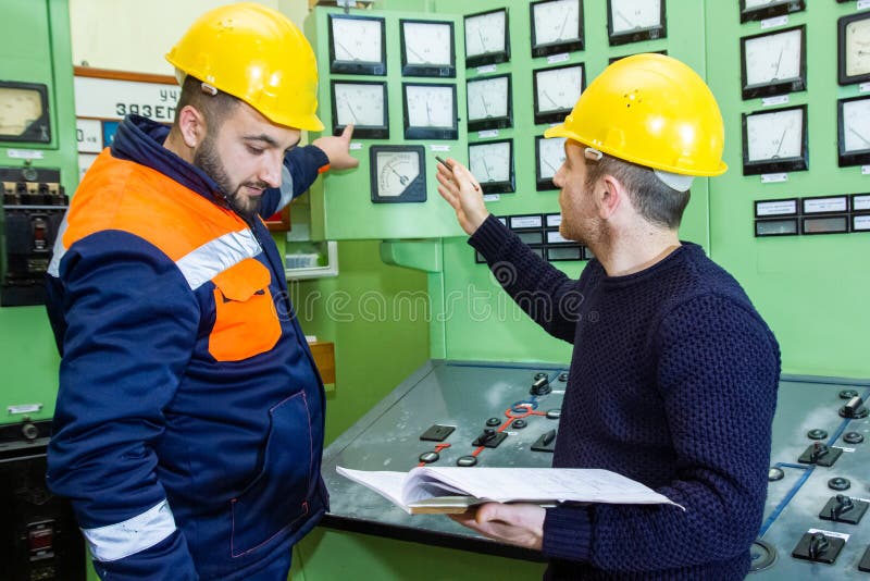 Electricians with Yellow Helmet Working in a Power Station Stock Image ...