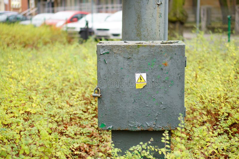 Electricity Box with Warning Sticker by a Green Bush. Stock Photo ...