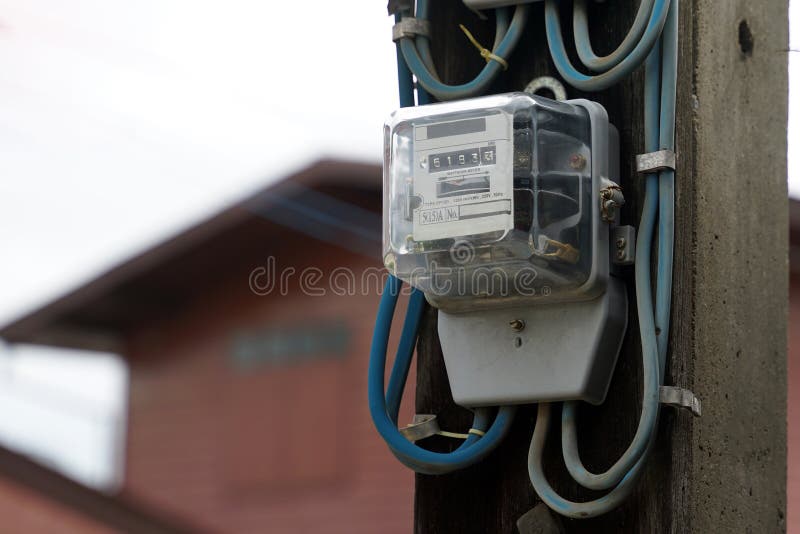 An Electricity Meter is Installed on a Light Pole in Front of the House ...