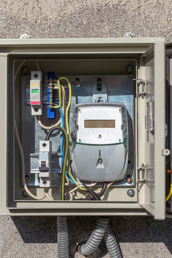 Electricity Meter in a Protective Metal Casing on a Stone Wall Stock ...