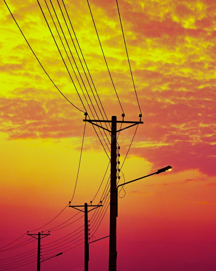 Electricity Poles Silhouetted Against Dusk Sky, Yellow and Purple Sky ...