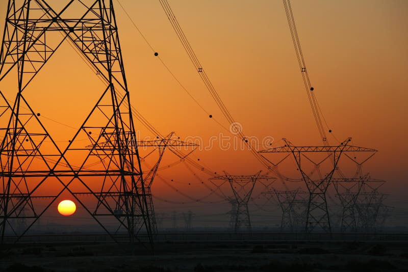 Electricity Pylons with Setting Sun Stock Photo - Image of electricity ...