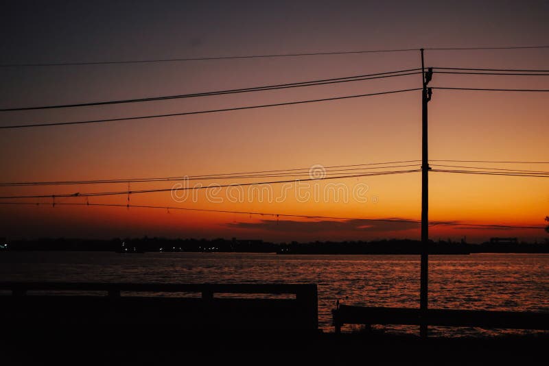 Electricity Pylons with Wire Cable and Street Lamp Post at Sunset Stock ...