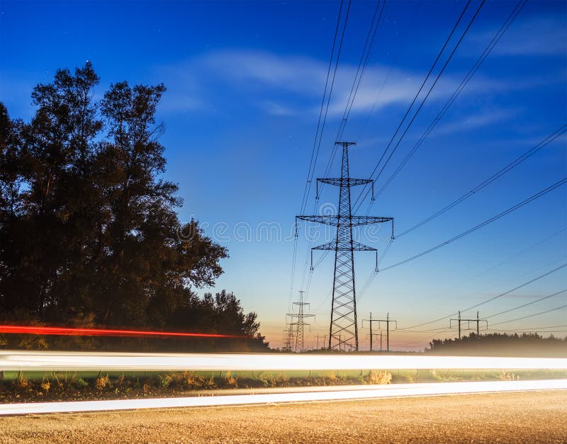 Electricity Transmission Power Lines at Sunset High Voltage Tower ...