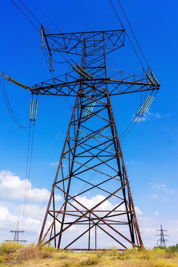 Electricity Transmission Pylon Silhouetted Against Blue Sky. Stock ...