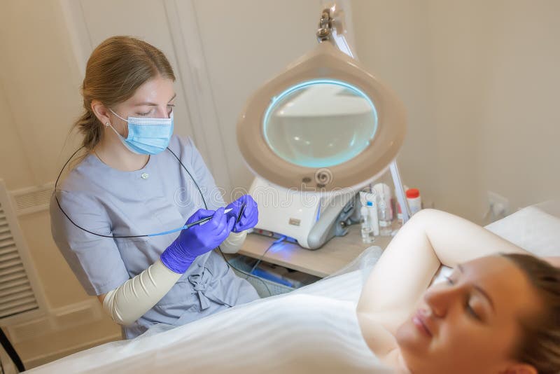 The Electroepilation Master Sits Opposite the Client and Prepares for ...