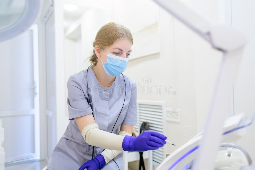 The Electroepilation Master Sits at the Workplace and Sets Up the ...