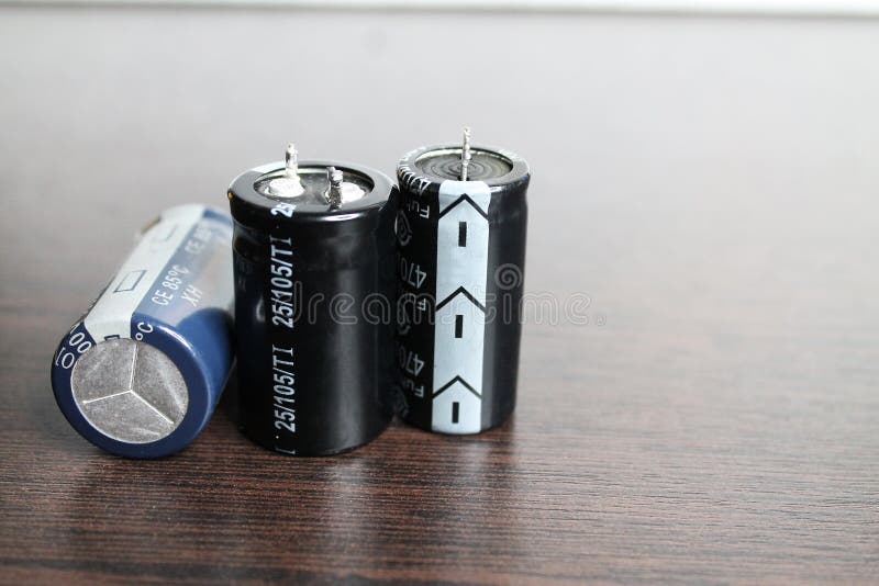 Electrolytic Capacitors on a Black Wood Background Stock Photo - Image ...
