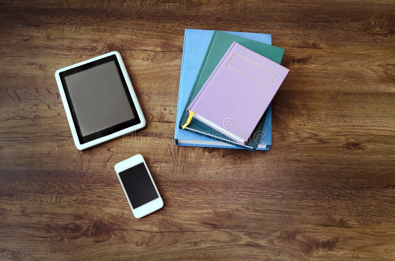 Electronic Book and Books are Paper with a Phone on a Wooden Tab Stock ...
