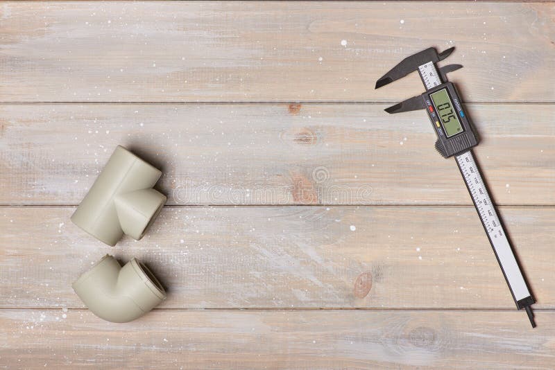 Electronic Calipers with Plastic Pipes on Wooden Table Stock Photo ...