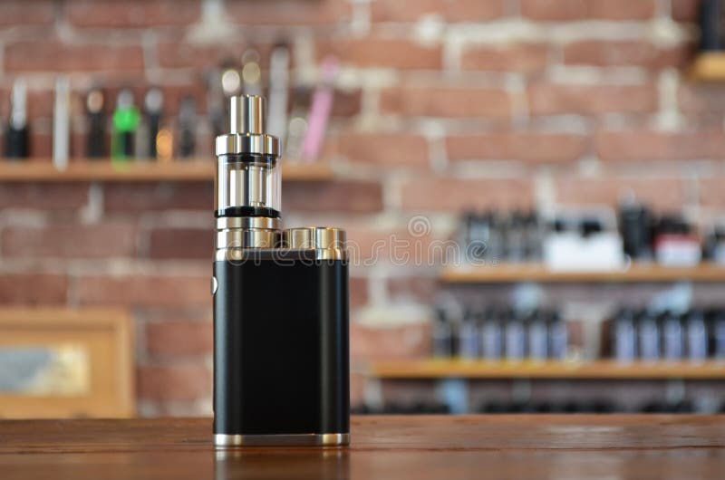 Electronic Cigarette on a Background of Vape Shop. E-cigarette for ...