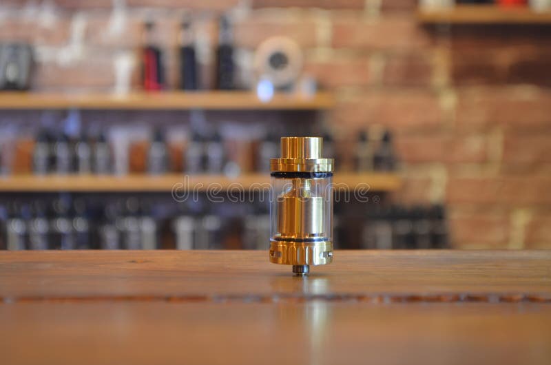 Electronic Cigarette on a Background of Vape Shop. E-cigarette for ...