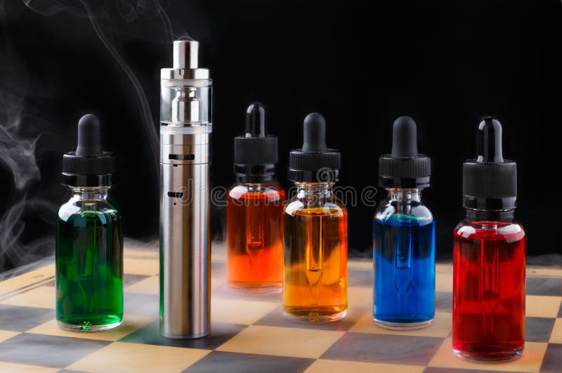 Electronic Cigarette and Vape Liquids within Vapor on Granite Surface ...