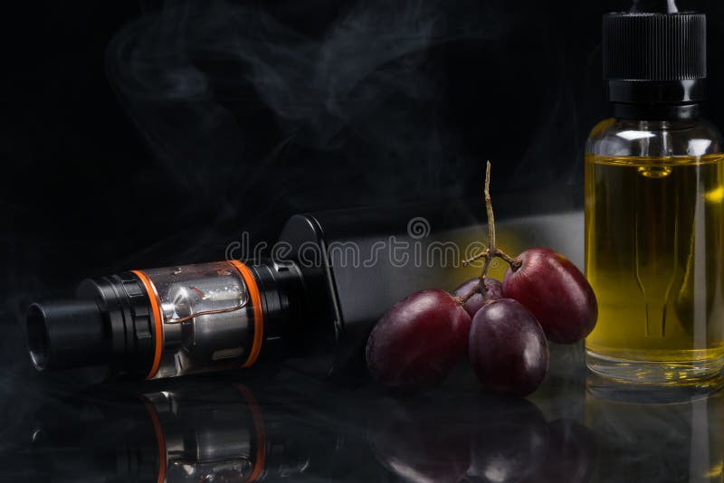 Electronic Cigarette and Grapes with a Bottle of Liquid in the Smoke on ...