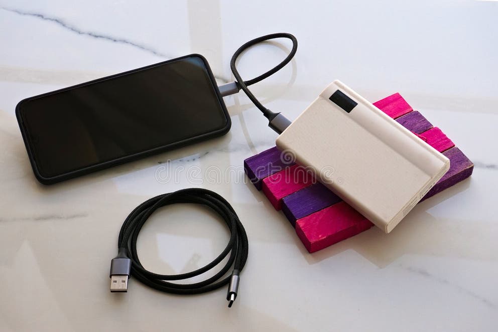 Electronic Device Charging Battery with a Portable Power Bank on the ...