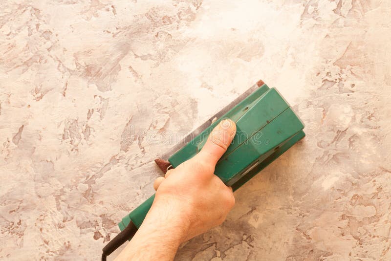 Electronic Grinder in a Hand. Grinding and Leveling the Surface of the ...