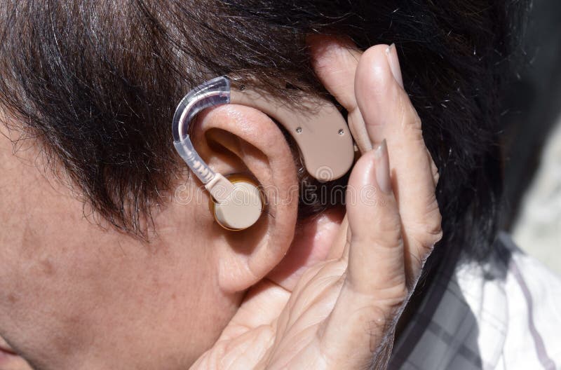 Electronic Hearing Aid Device in the Ear of Asian Old Man with Total ...