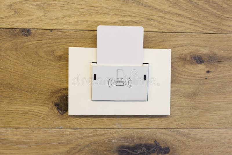Electronic Lock with Card Inserted and Light Switches on Wooden Wall in ...