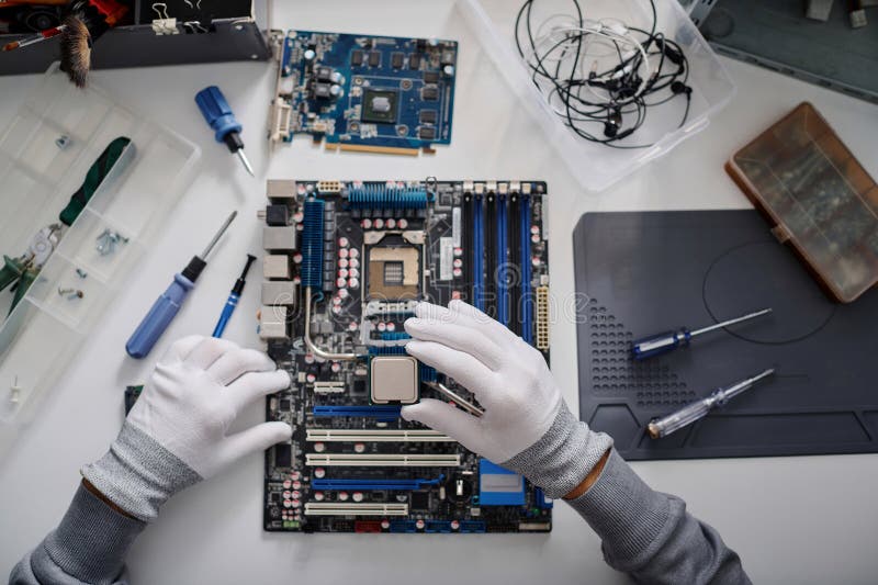 Electronic Repairman Working on CPU Installation into Computer Stock ...