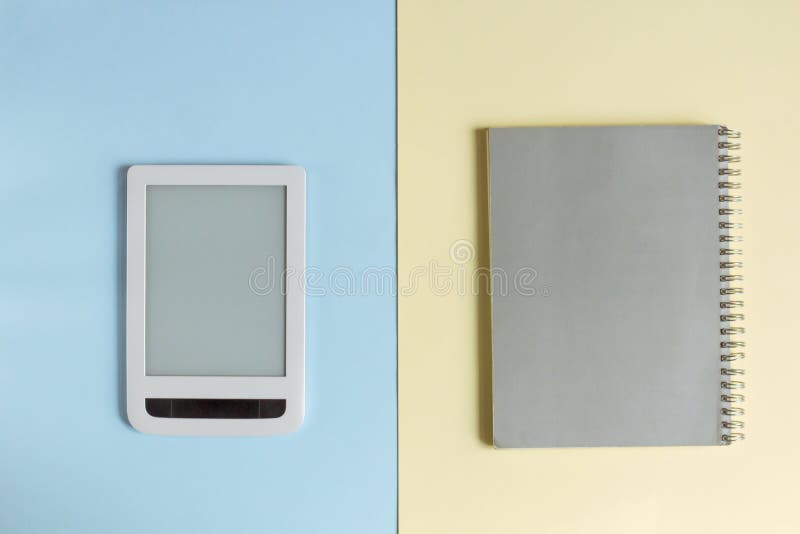Electronic Tablet and Paper Notebook on Blue and Yellow Pastel ...