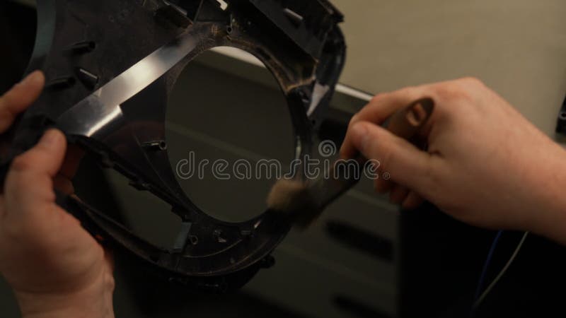 Electronic Technician Cleaning Gaming Console Interior with Small Brush ...