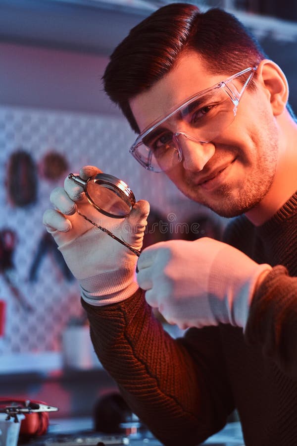 Electronic Technician Mending a Broken Tablet Carefully Examines the Chip of the Tablet Using a ...