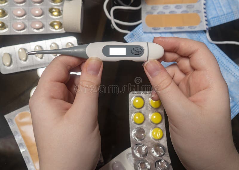 An Electronic Thermometer with a Clean White Screen in the Hands Stock ...