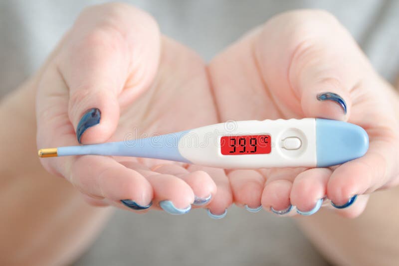 Electronic Thermometer in a Female Hands. Elevated Body Temperature ...